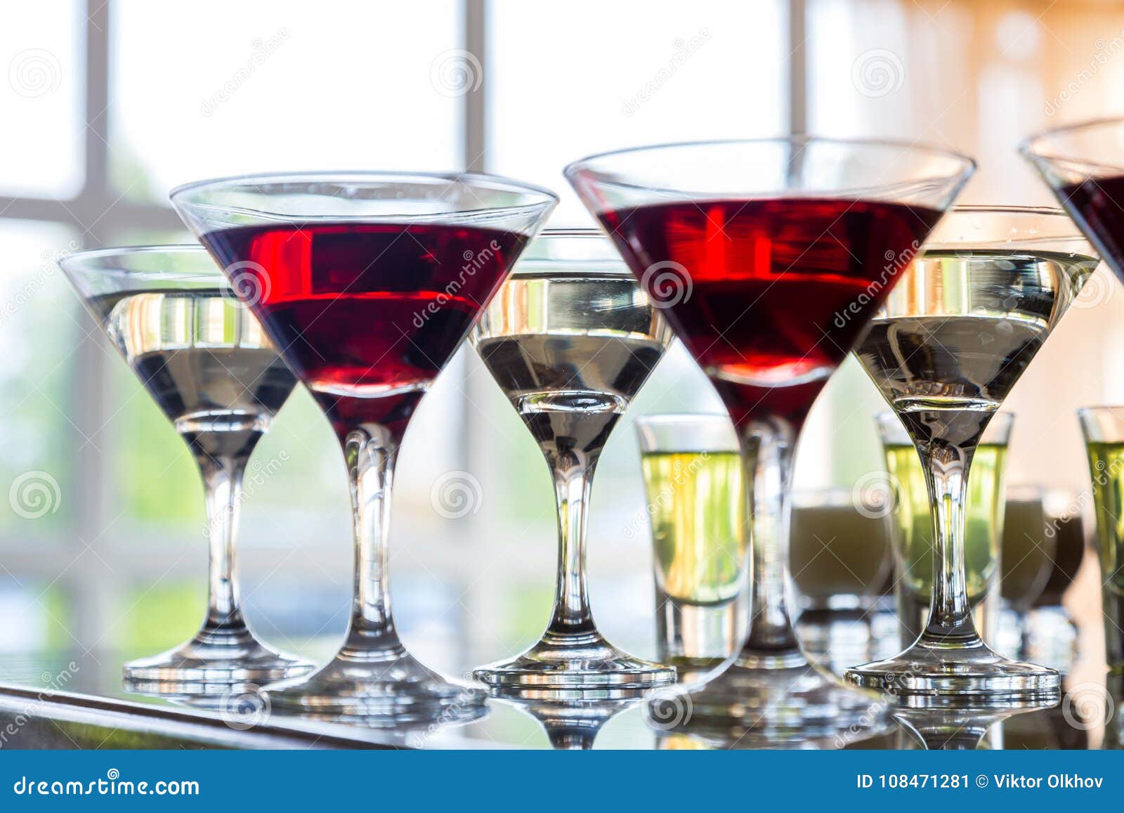 Several Glasses of the Famous Martini Cocktail Stand on a Bar Table ...