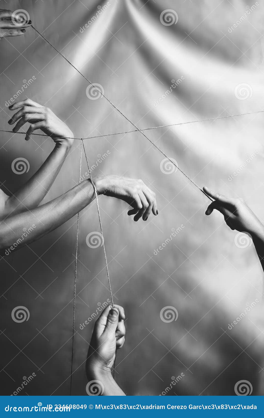 Several Hands Joined and Connected through a Taut Thread. Black and ...