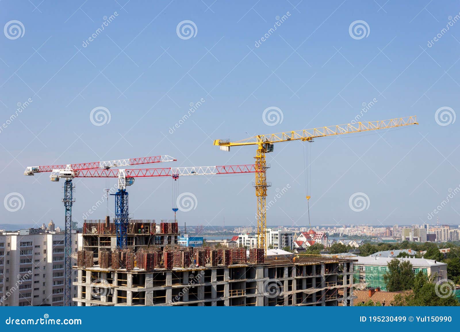 Several High-rise Cranes at a Construction Site, Together with People ...