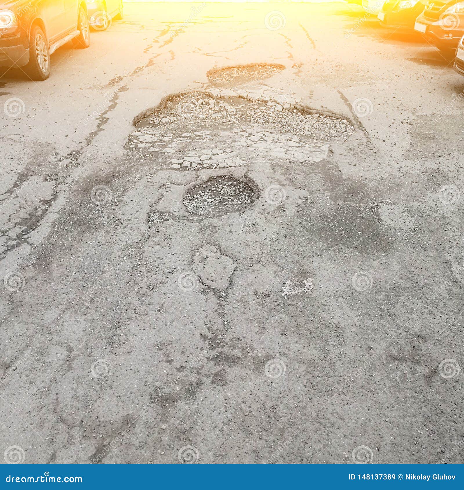 Several Large Pits on the Gray Asphalt in the Yard. Stock Image - Image ...
