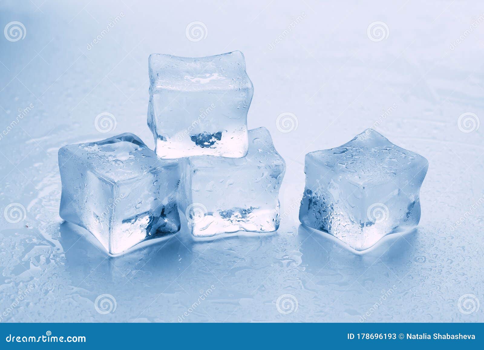 Several Melted Ice Cubes with Drops on a Light Background with Blue ...