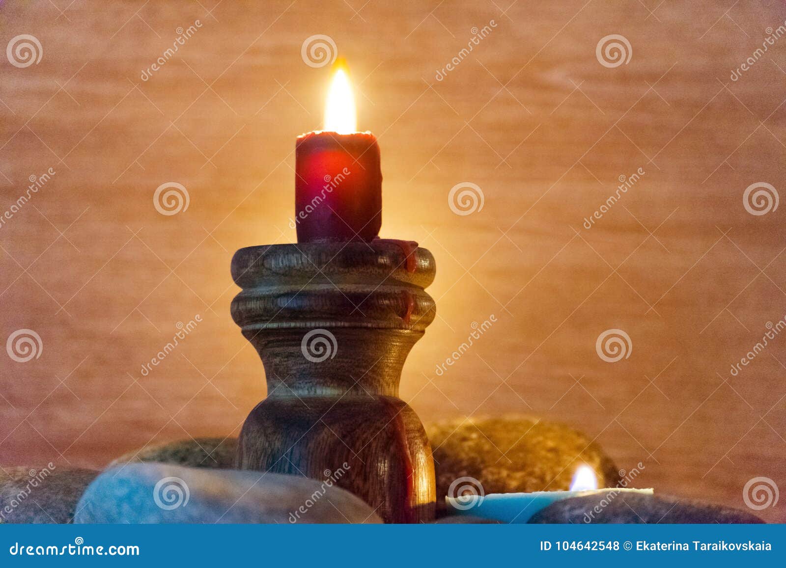 Several Multi-colored Candles are Lit and Surrounded by Stones. Stock ...