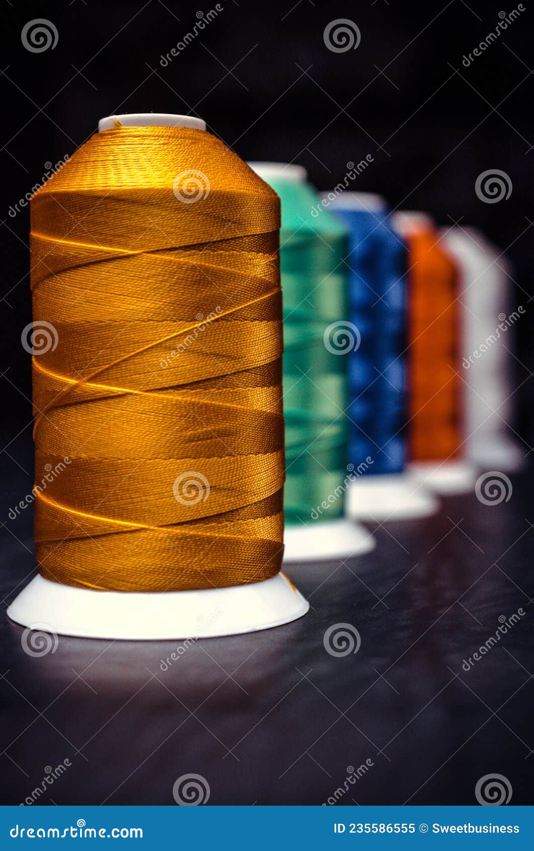 Several of Multi-colored Spools of Threads. Perspective on a Black ...