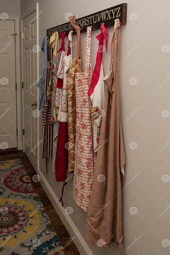 Several Old Aprons on Hooks Stock Image - Image of apparel, fashion ...