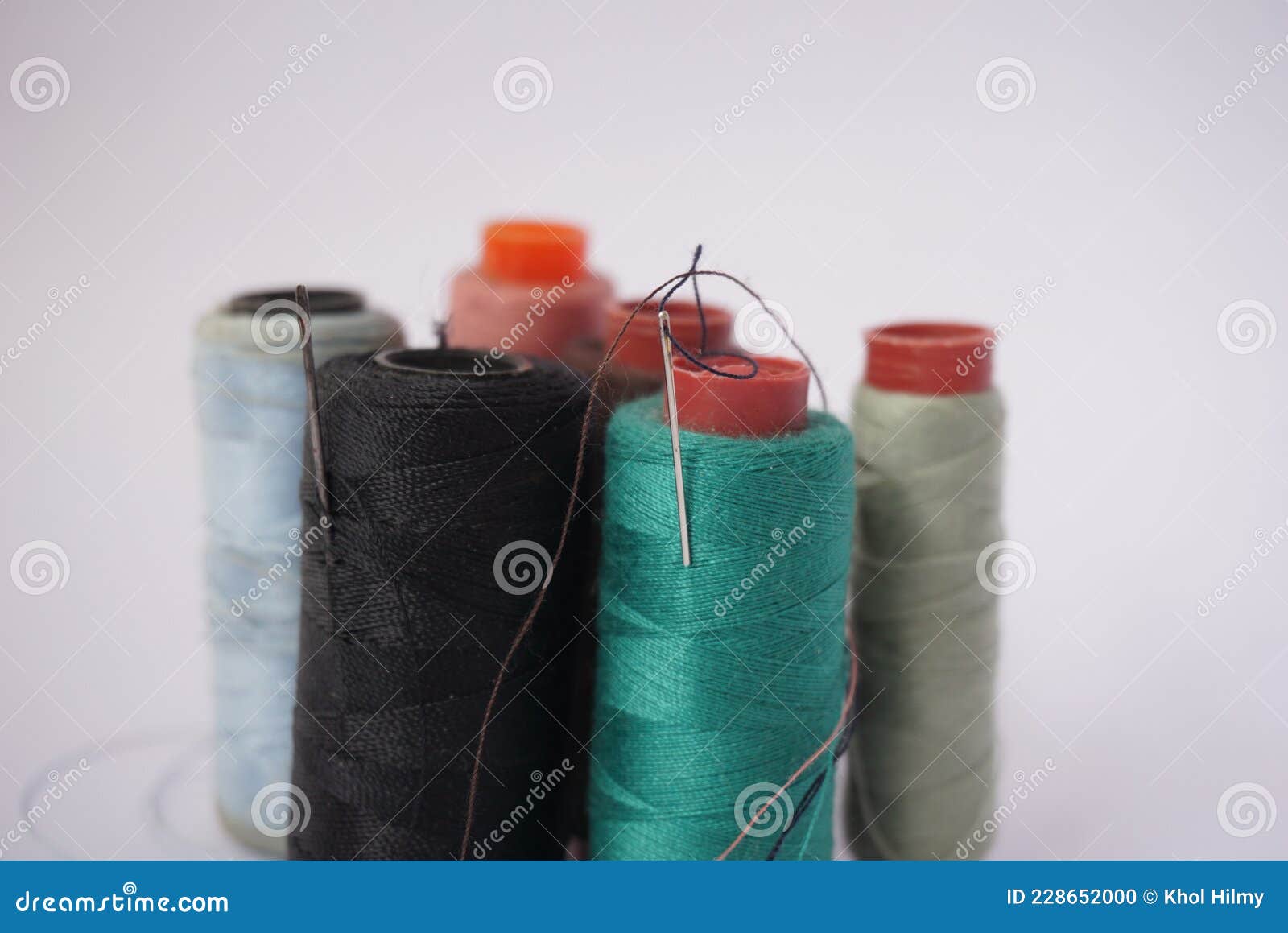Several Piles of Sewing Thread Spools of Various Colors Isolated on a ...