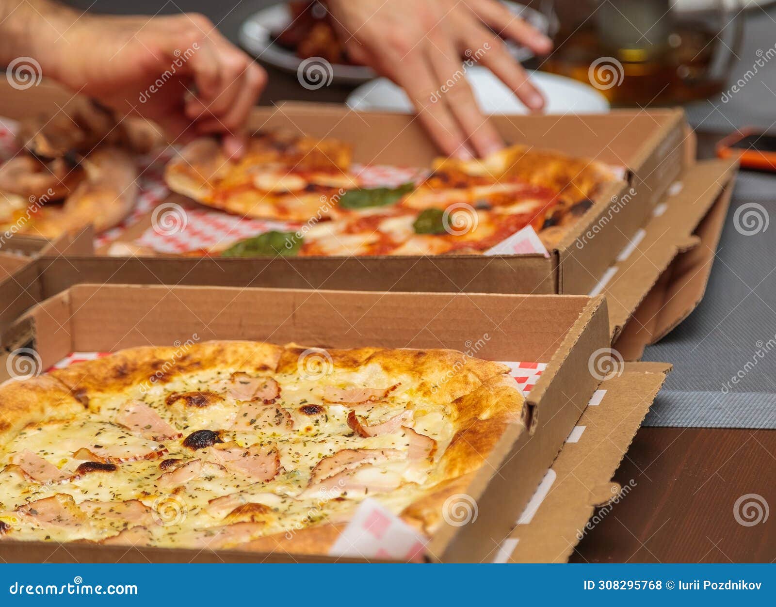 Several Pizzas in Cardboard Boxes are Sitting on a Table Stock Photo ...