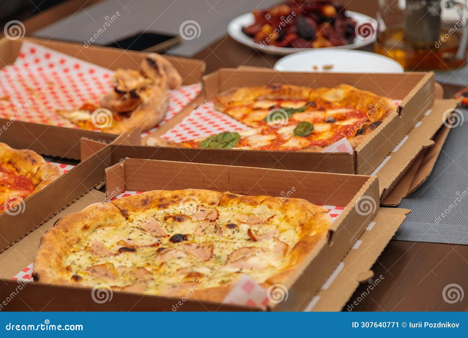 Several Pizzas in Cardboard Boxes are Sitting on a Table Stock Image ...
