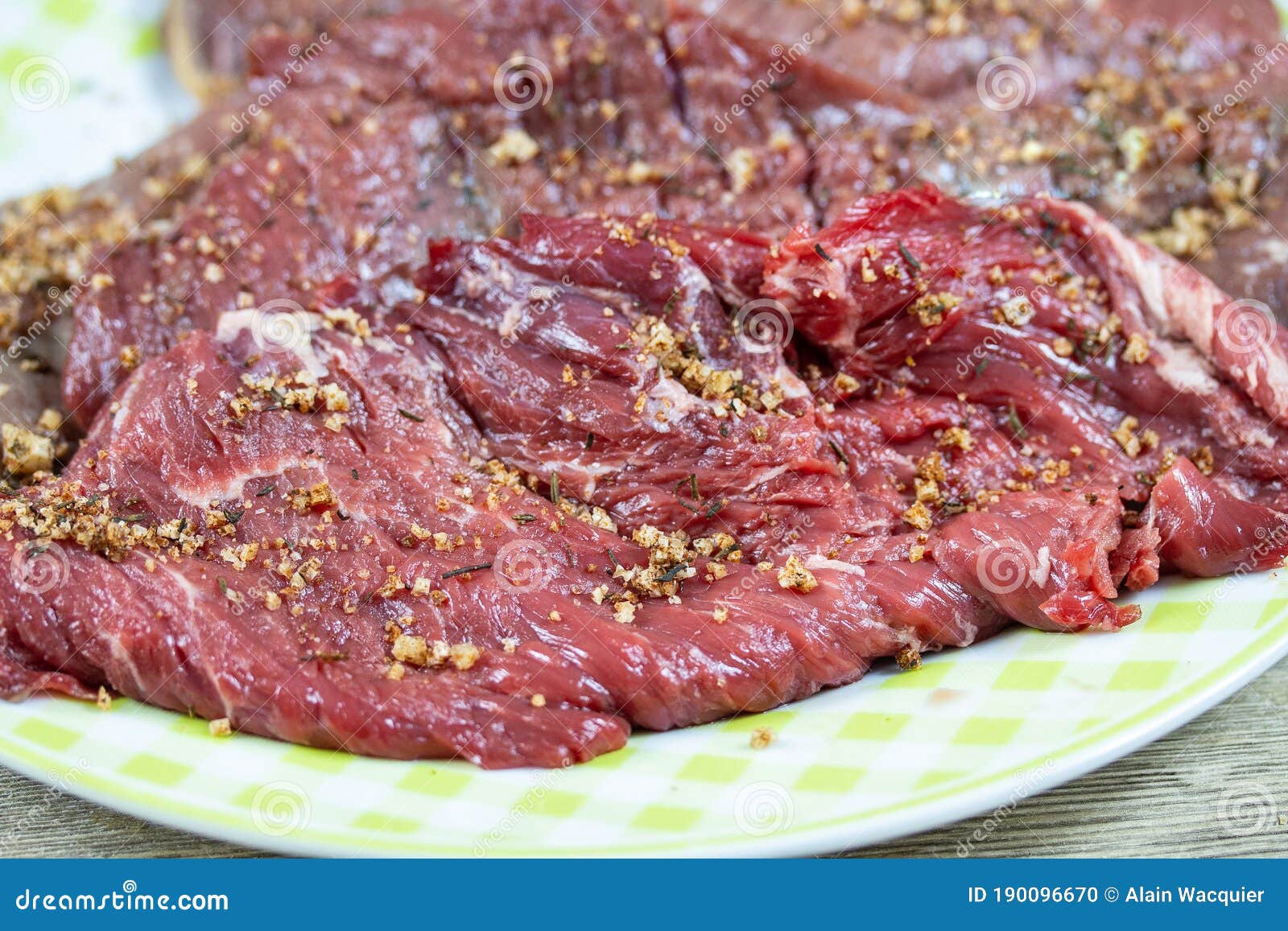 Raw beef flank on a plate stock photo. Image of flank - 190096670