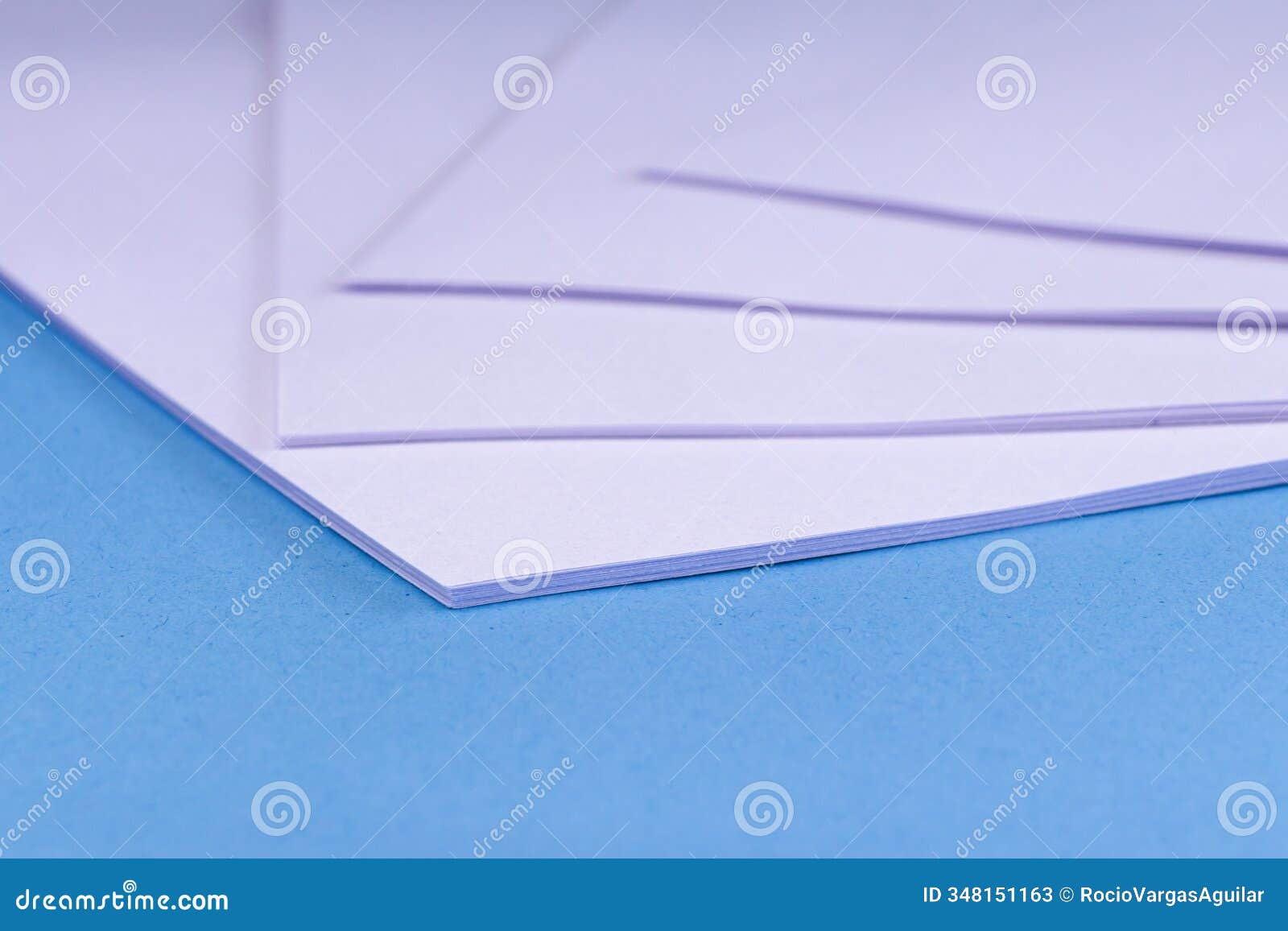 Several Sheets of White Bond Paper on a Light Blue Background Stock ...
