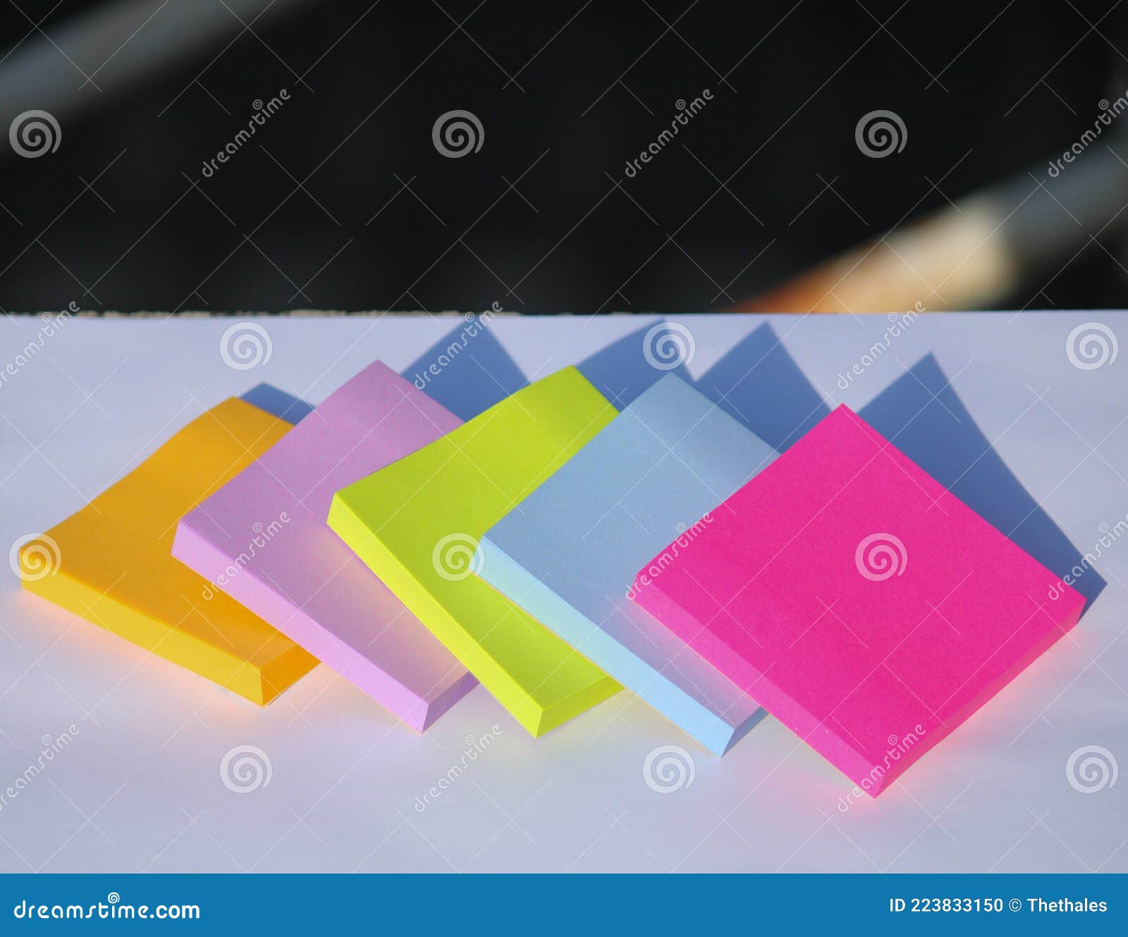 Several Sitcky Note Blocks Stacked in a Row on a Piece of White Paper ...