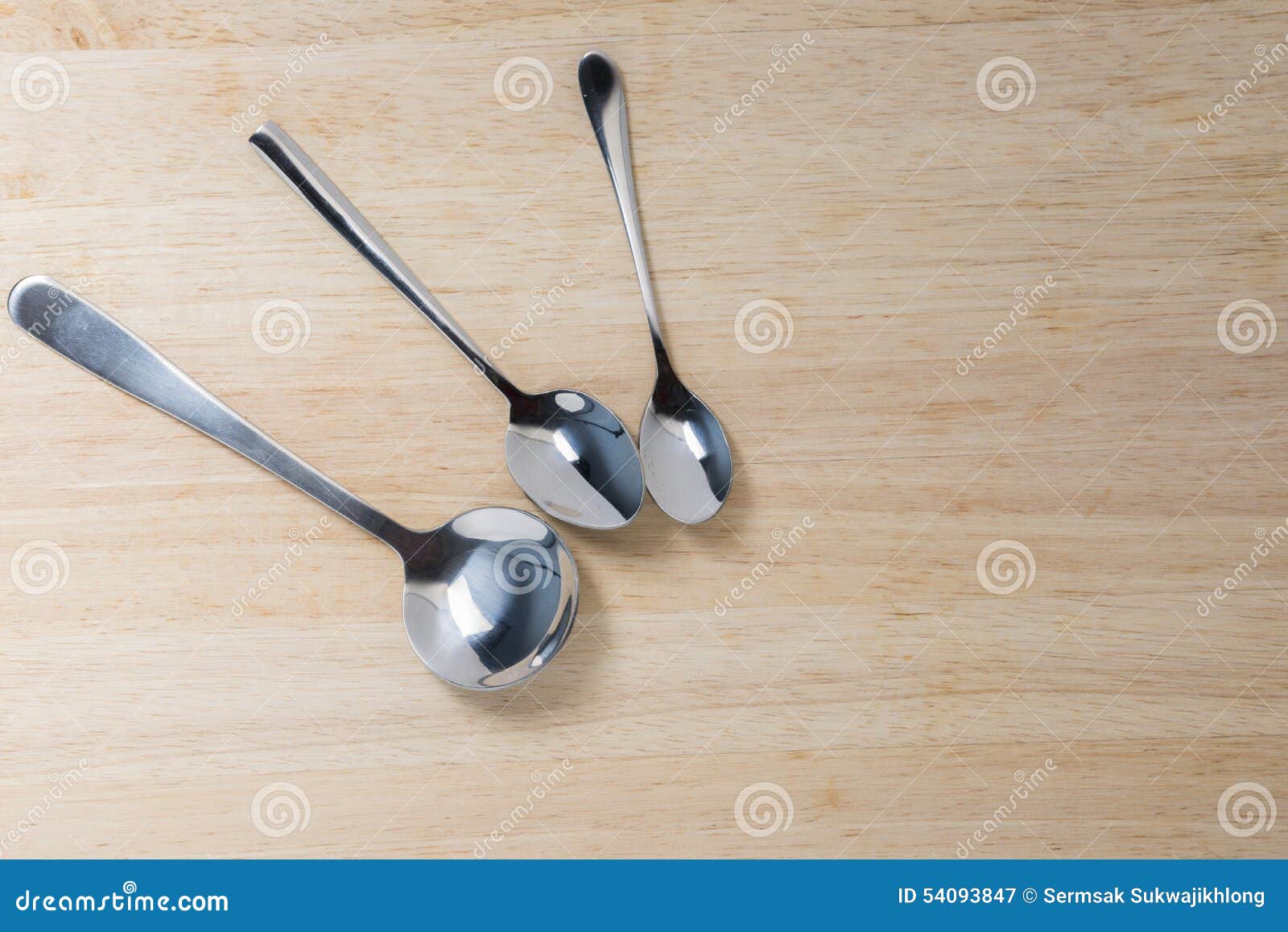 Several Sizes of Spoons Isolated on Wooden Table Stock Image - Image of ...