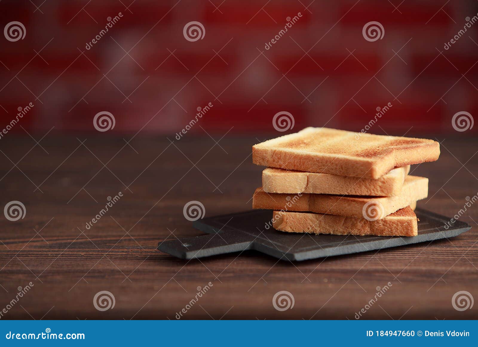 Several Slices of Toasted Bread Toasts on a Wooden Dark Background ...