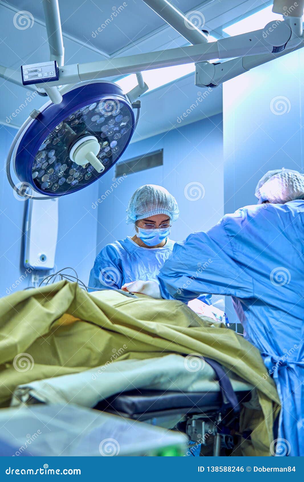 Several Surgeons Surrounding Patient on Operation Table during Their ... Several Surgeons Surrounding Patient on Operation Table during Their ...
