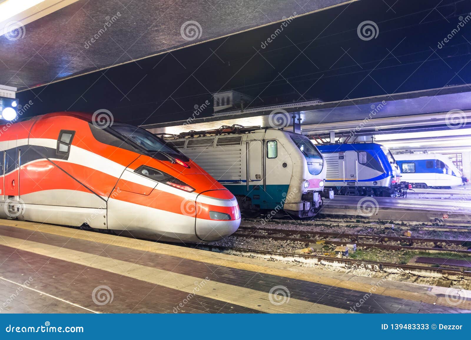 Several Trains Stand in a Row on Different Tracks at the Train Station ...