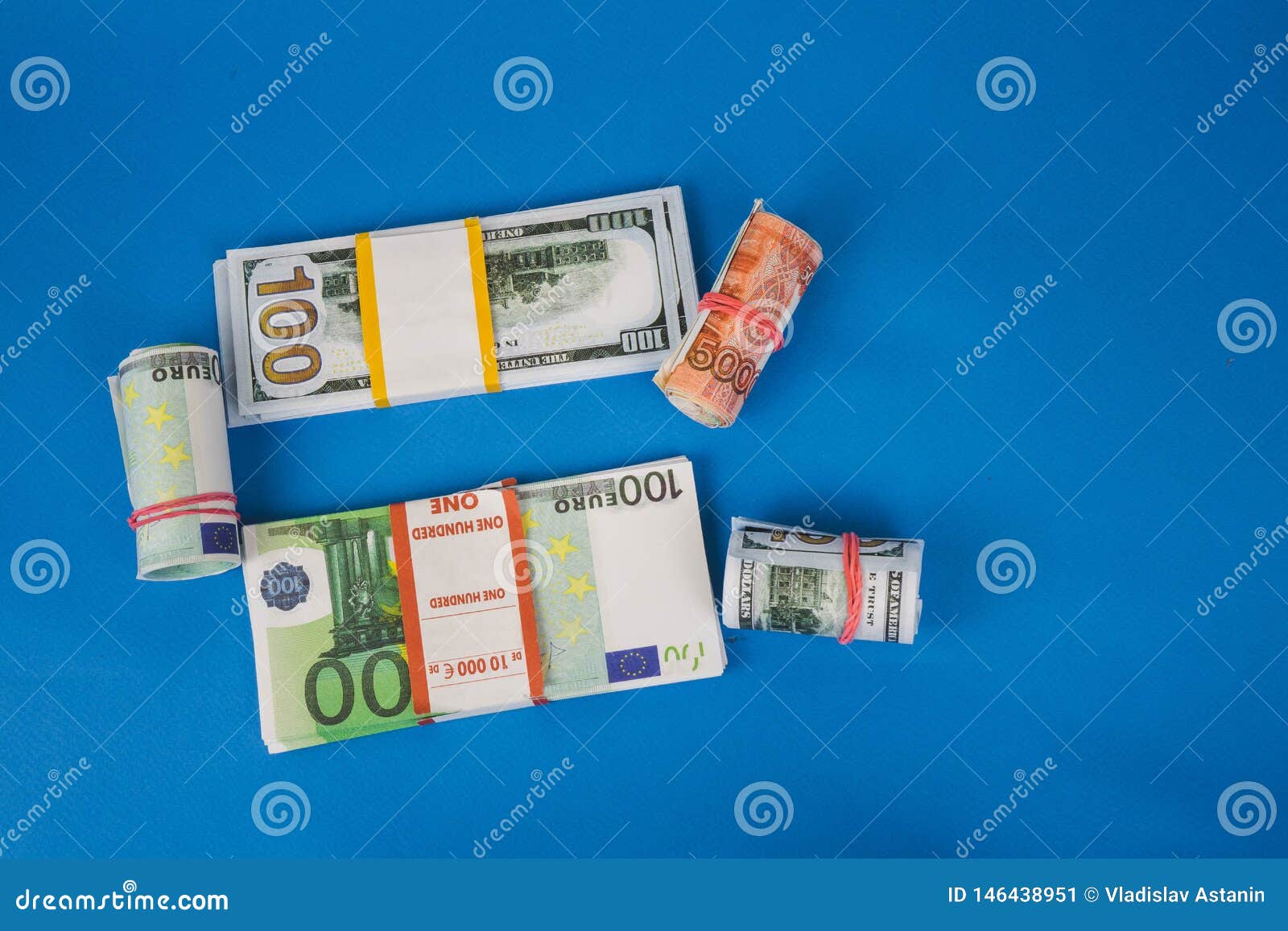 Several Wads of Money of Different Currencies on a Blue Background ...