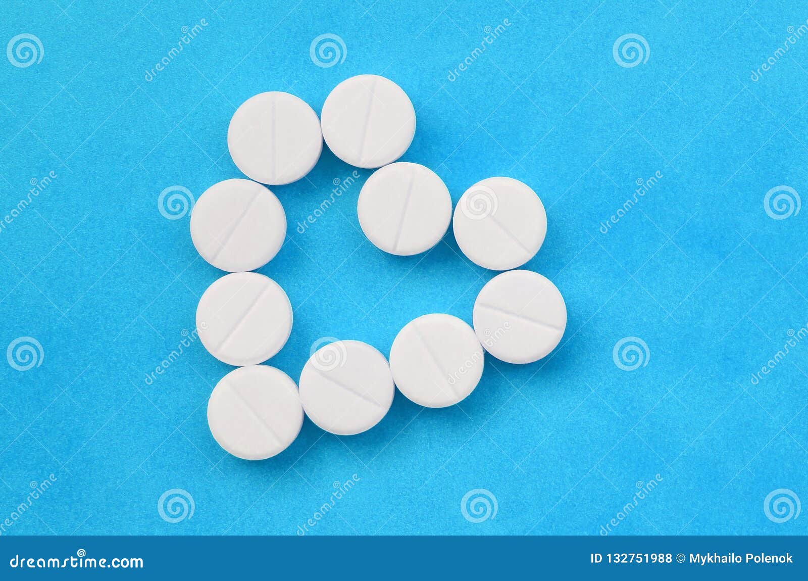Several White Tablets Lie on a Bright Blue Background in the Shape of a ...