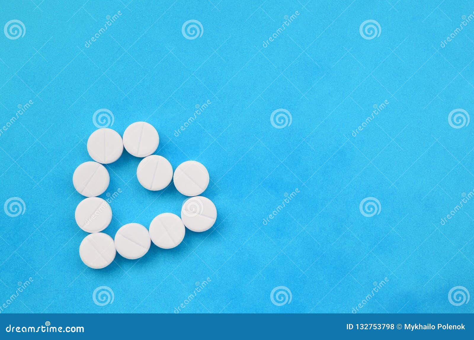 Several White Tablets Lie on a Bright Blue Background in the Shape of a ...