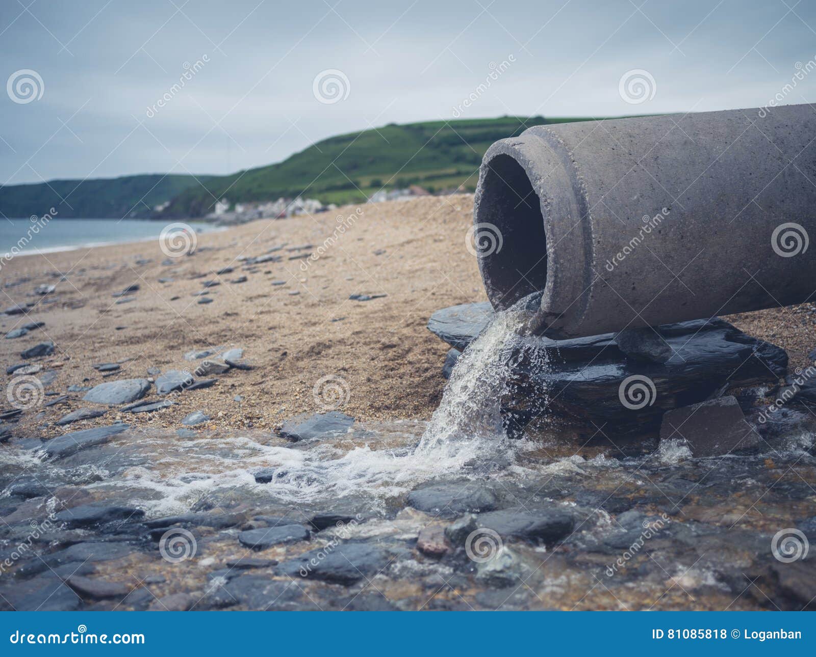 Sewage pipe on the beach stock photo. Image of sewer - 81085818
