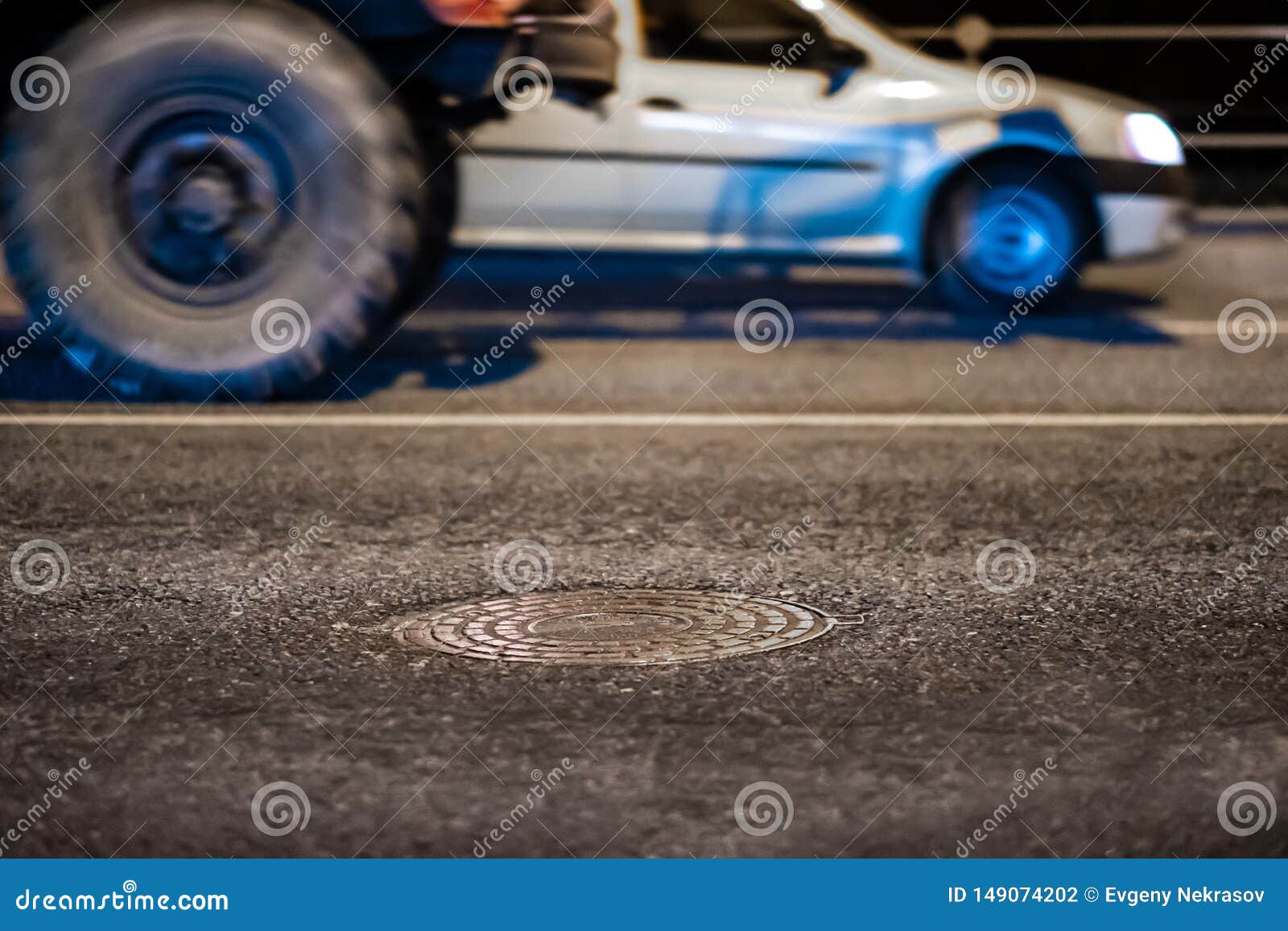 Sewer Manhole on Asphalt at Night, Cars Passing by Stock Photo - Image ...