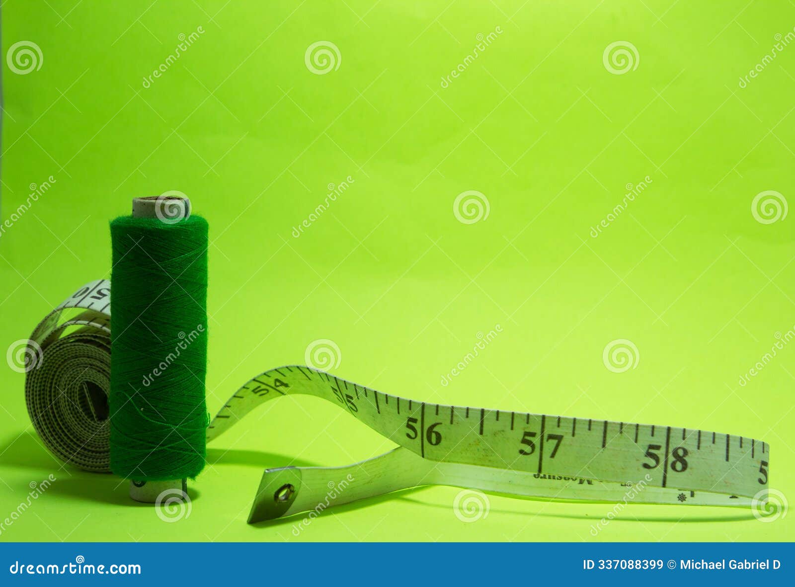 Sewing Accessories Thread Bundle with Measurement Tape Green Background ...