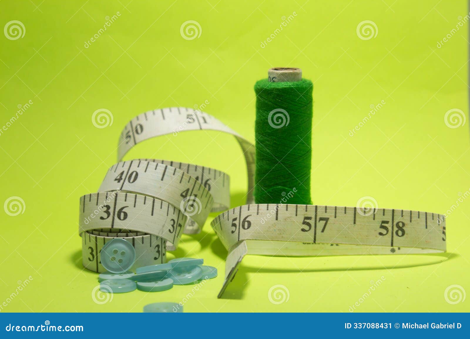 Sewing Accessories Thread Bundle with Measurement Tape Green Background ...