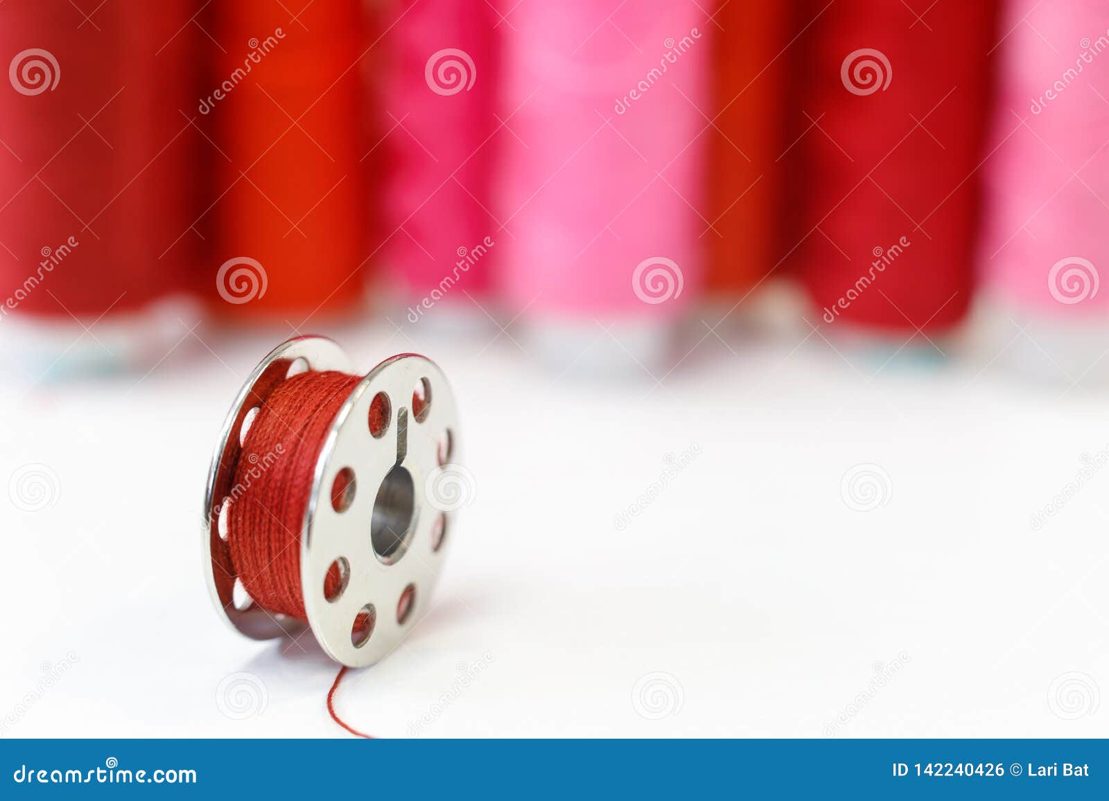 Sewing Bobbin and Row of Spools of Thread Stock Photo - Image of bobbin ...
