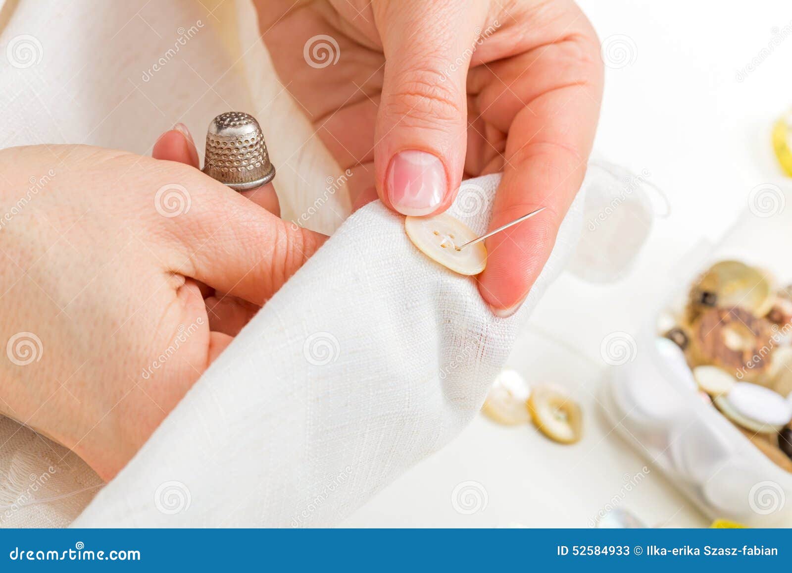 Sewing button on cloth stock image. Image of hand, female - 52584933