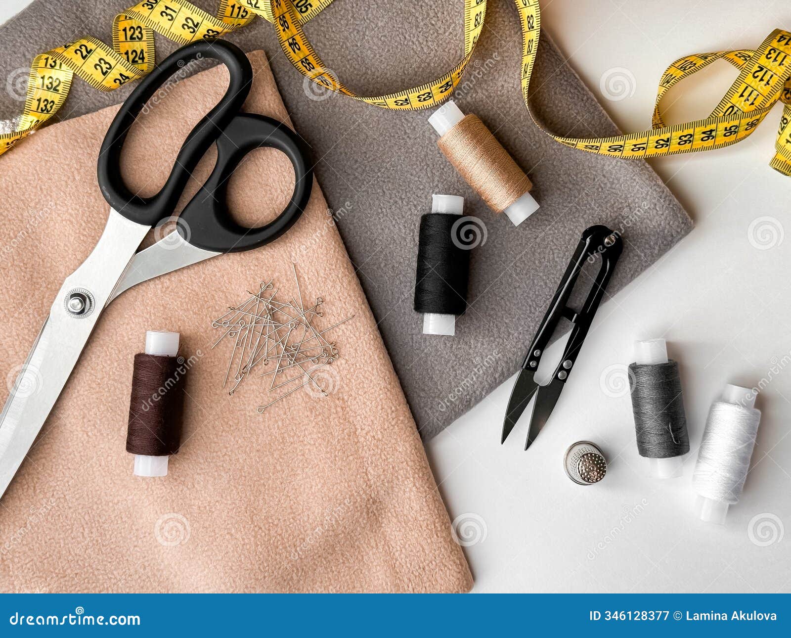 Sewing Essentials with Scissors, Measuring Tape, and Thread on Fabric ...