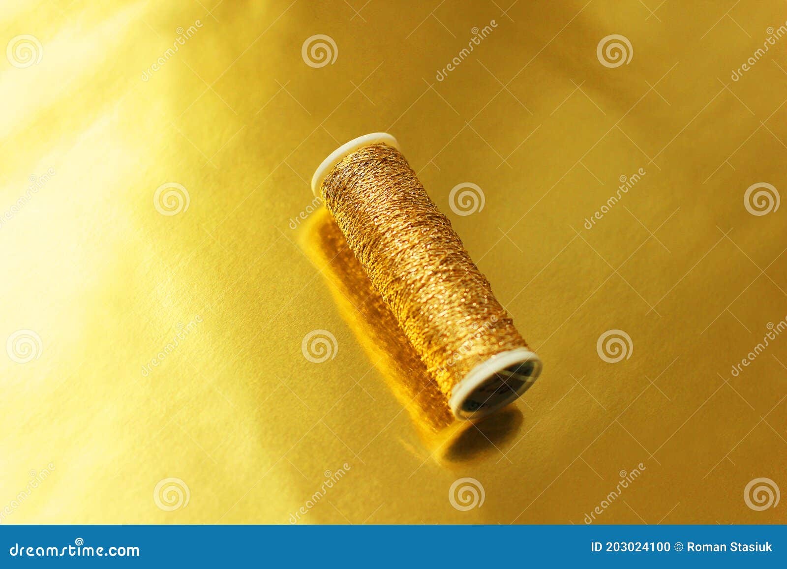Sewing Gold Threads on a Gold Background. Bright Shiny Threads Stock ...