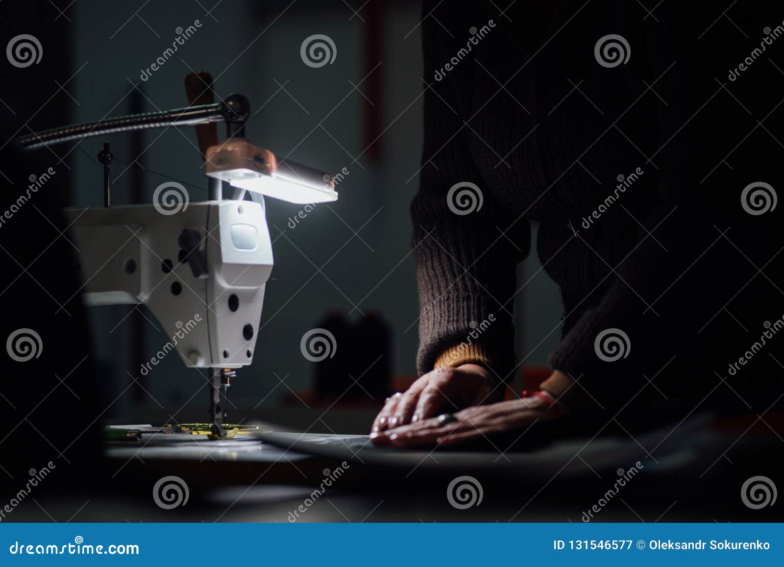 Sewing machine in dark stock image. Image of light, factory - 131546577