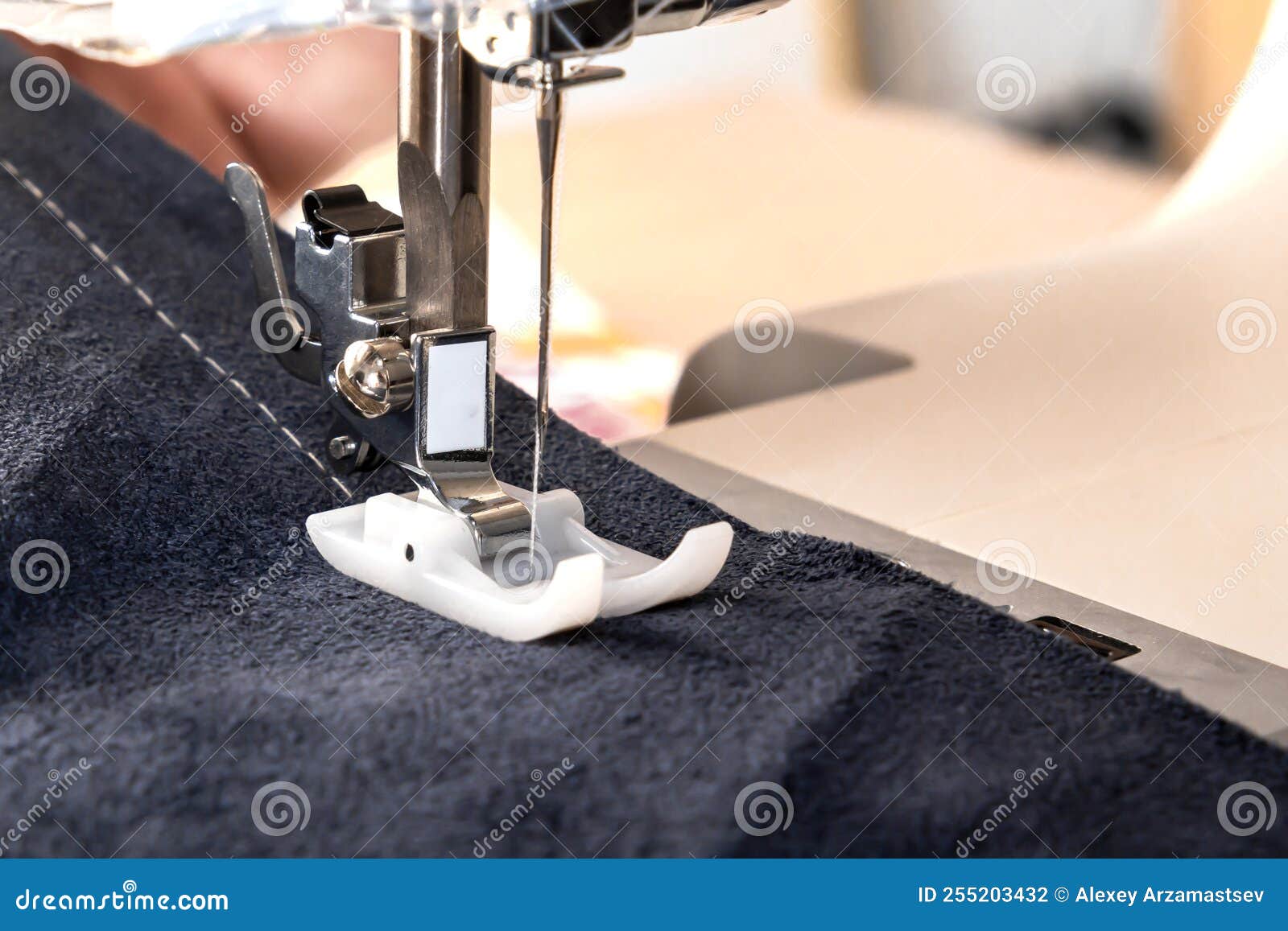 Sewing Machine Foot with a Needle Sews Fabric. Close-up Stock Photo ...