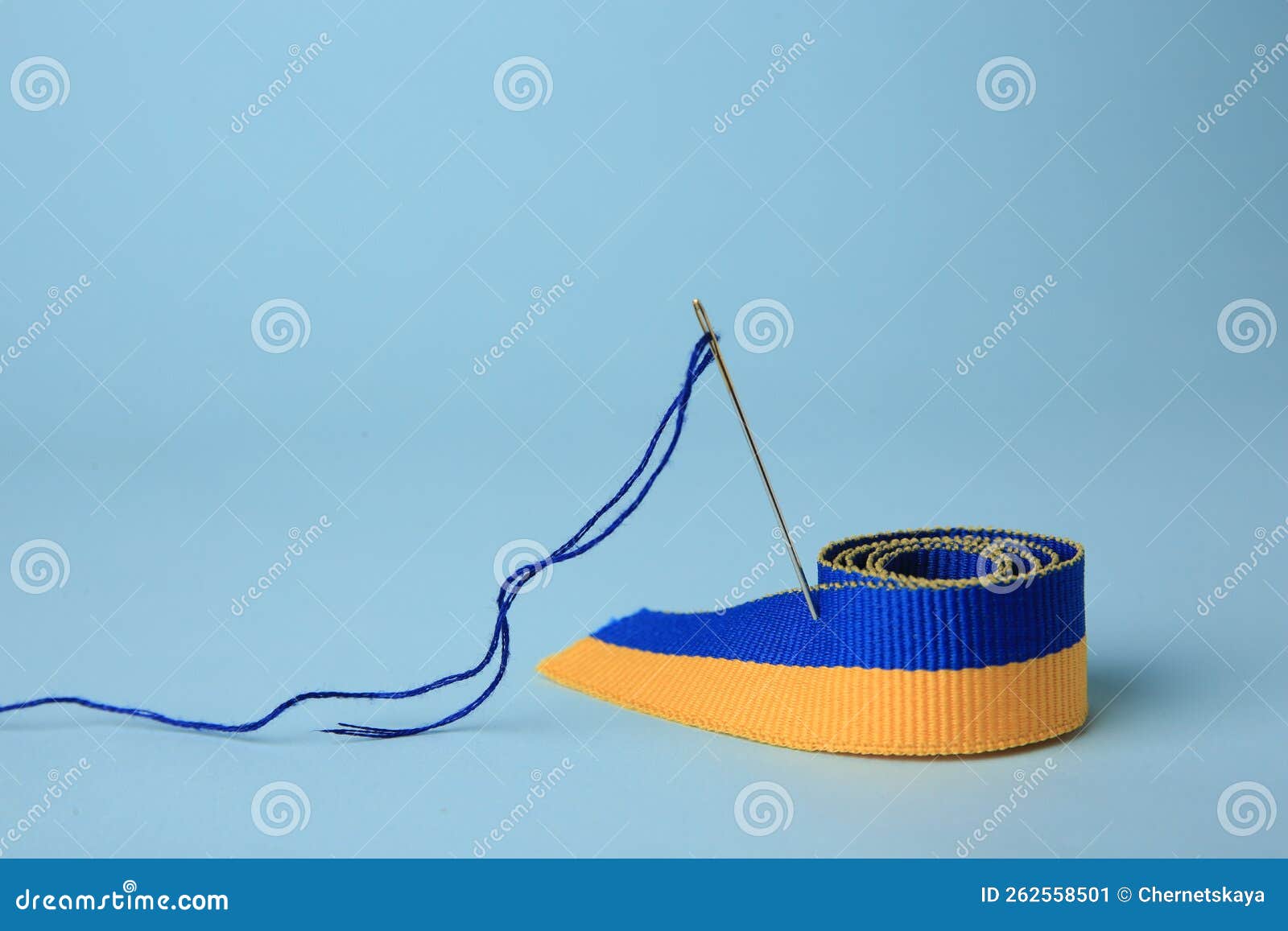 Sewing Needle with Thread and Color Ribbon on Light Blue Background ...