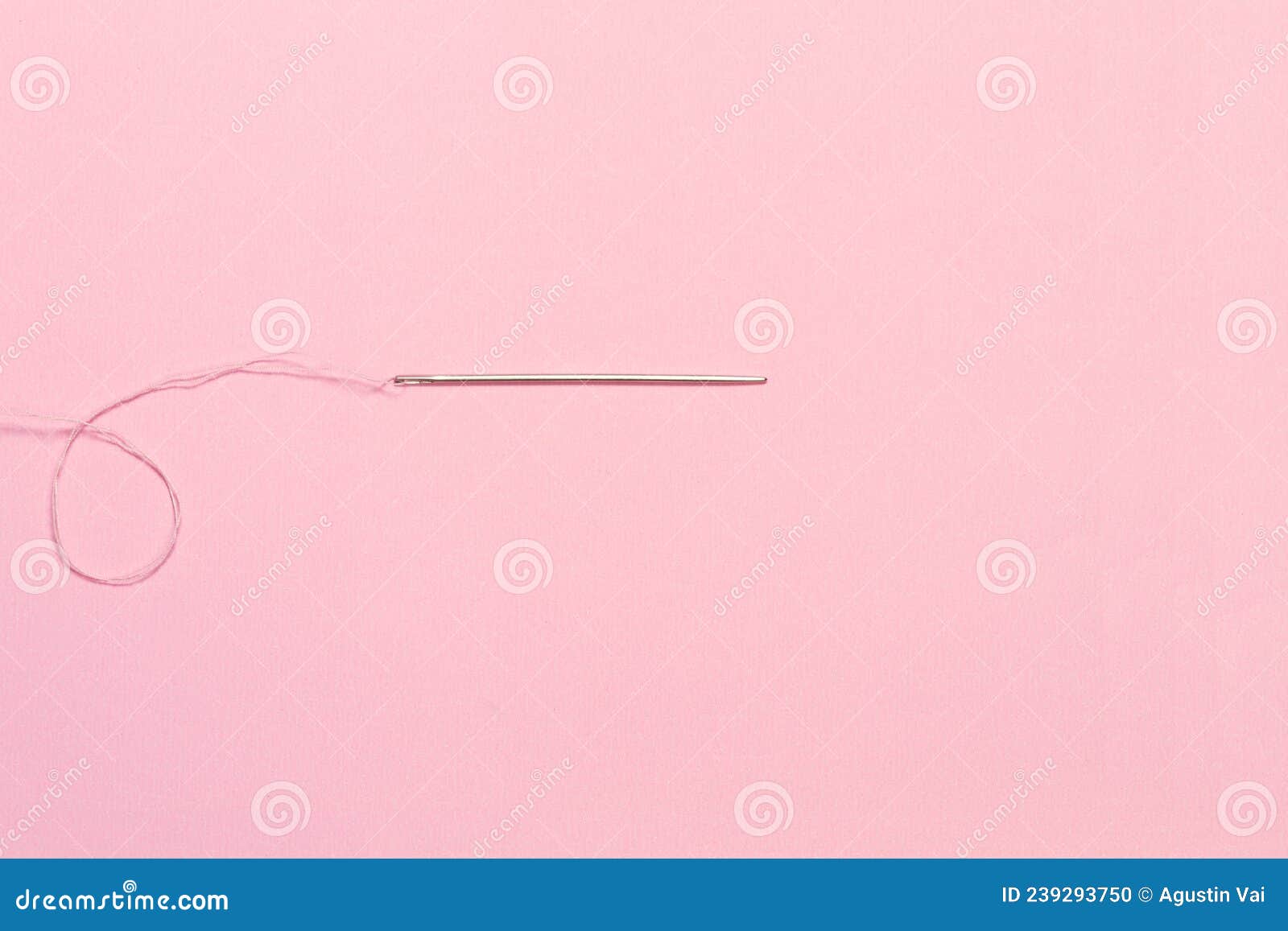 A Sewing Needle with a Thread on a Pink Background Stock Photo - Image ...