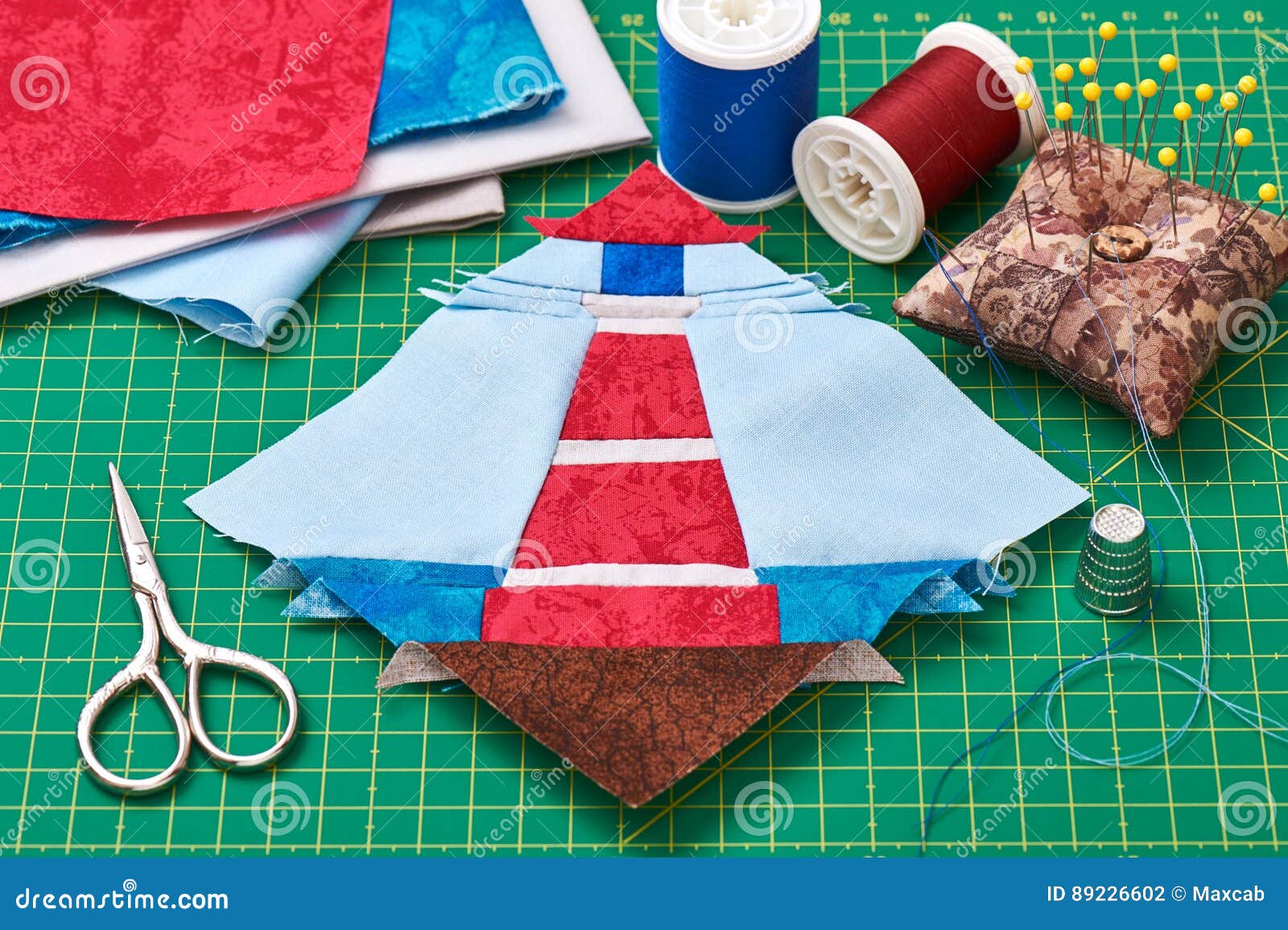 Sewing Patchwork of Block of Lighthouse Surrounded by Accessories Stock ...