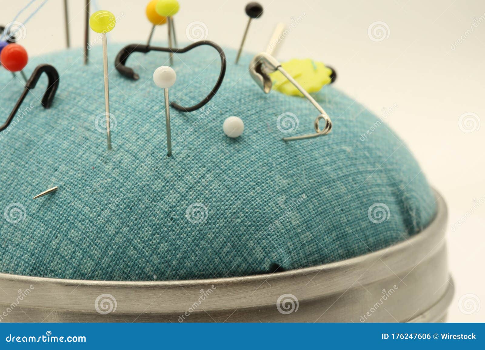 Sewing and Safety Pins on a Blue Pillow Stock Photo - Image of ...