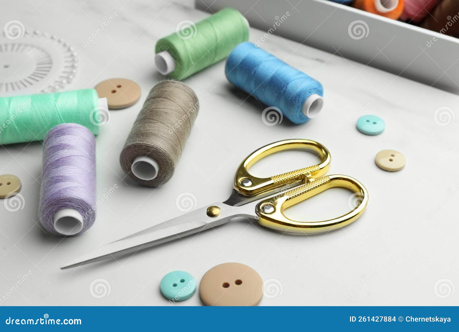 Sewing Threads, Scissors and Buttons on White Marble Table Stock Photo ...
