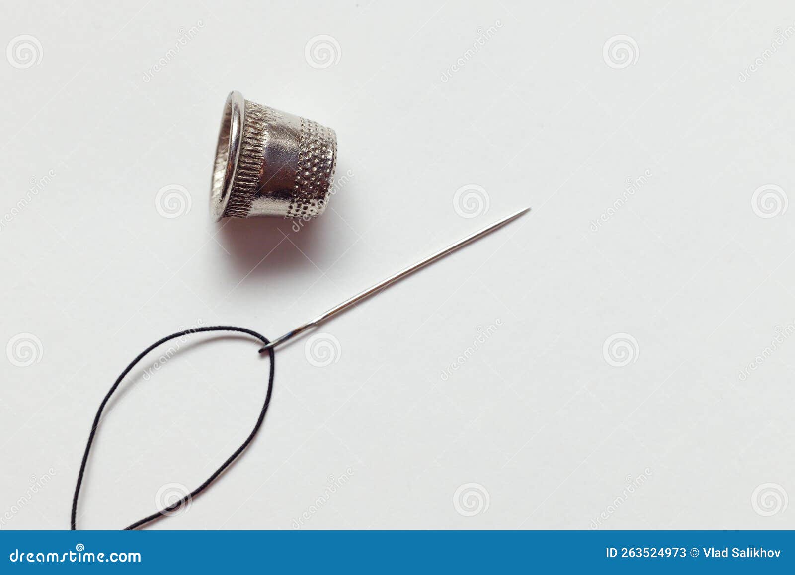 Sewing Tools on White Fabric Background.Needle, Thread, Thimble and ...