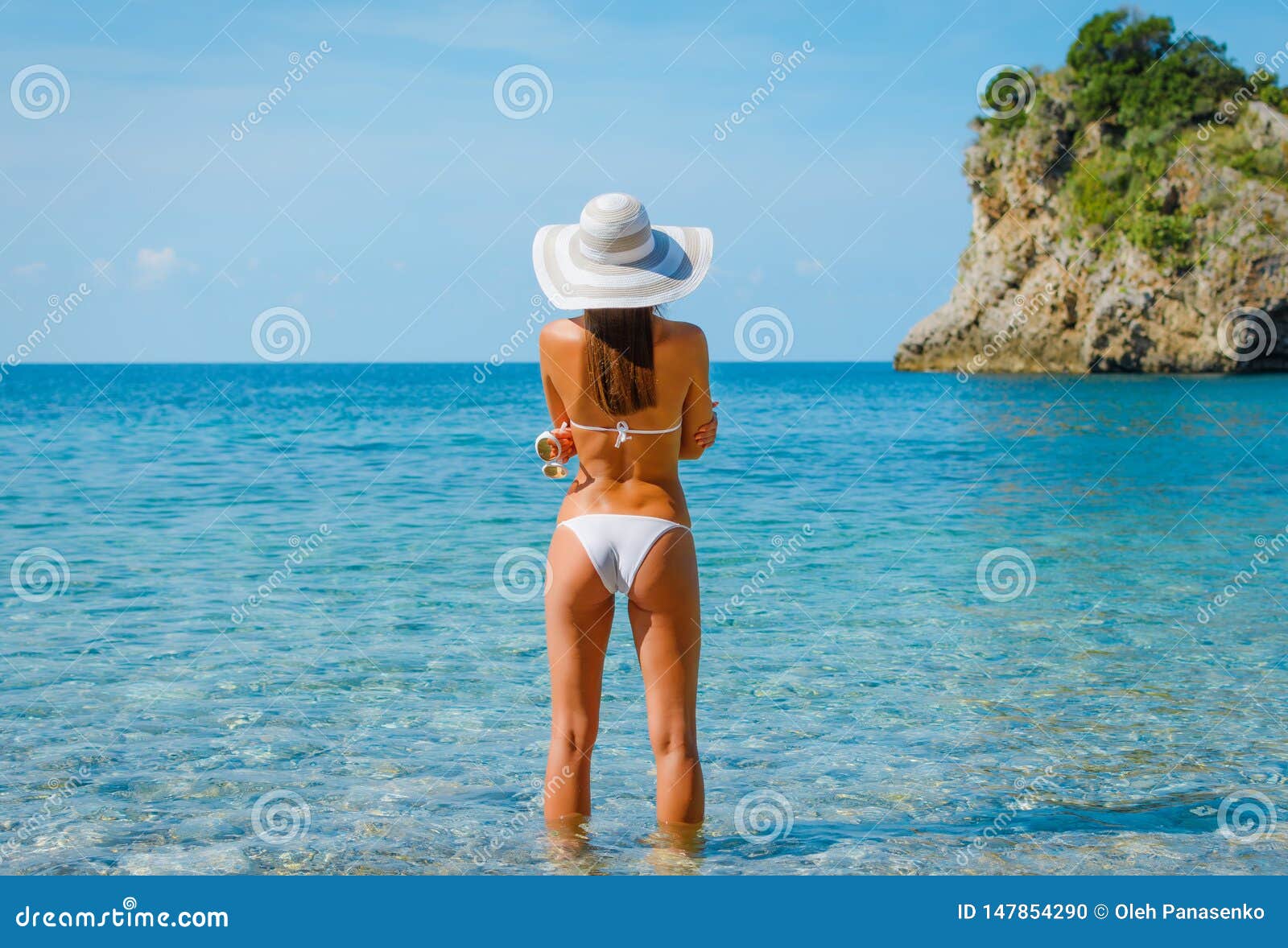 Beautiful Woman In White Bikini And Hat With Creative White Sunglasses