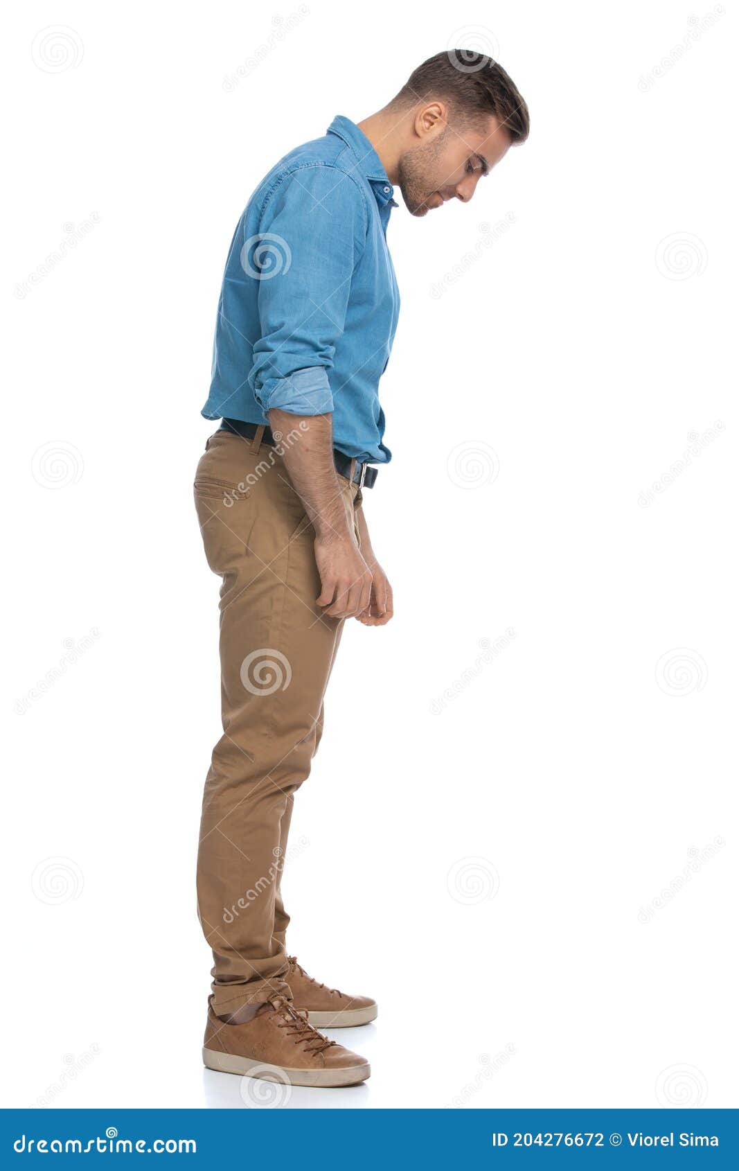 Casual Man Looking Down at Something Stock Photo - Image of male ...