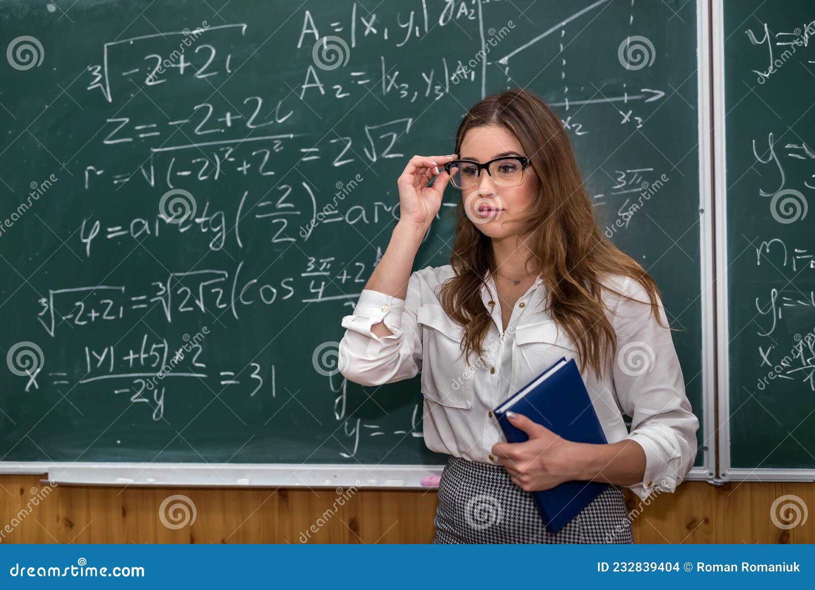 Caucasian Female Teacher Against Blackboard With Mathematical Formulas