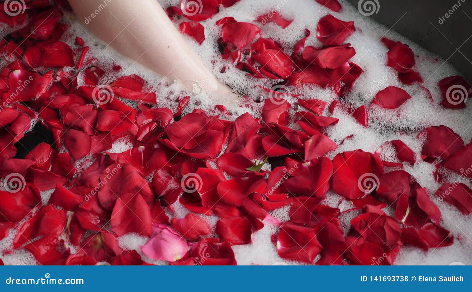 Girl Lies In A Big Stone Bath With A Rose Flower In Her Hands Stock