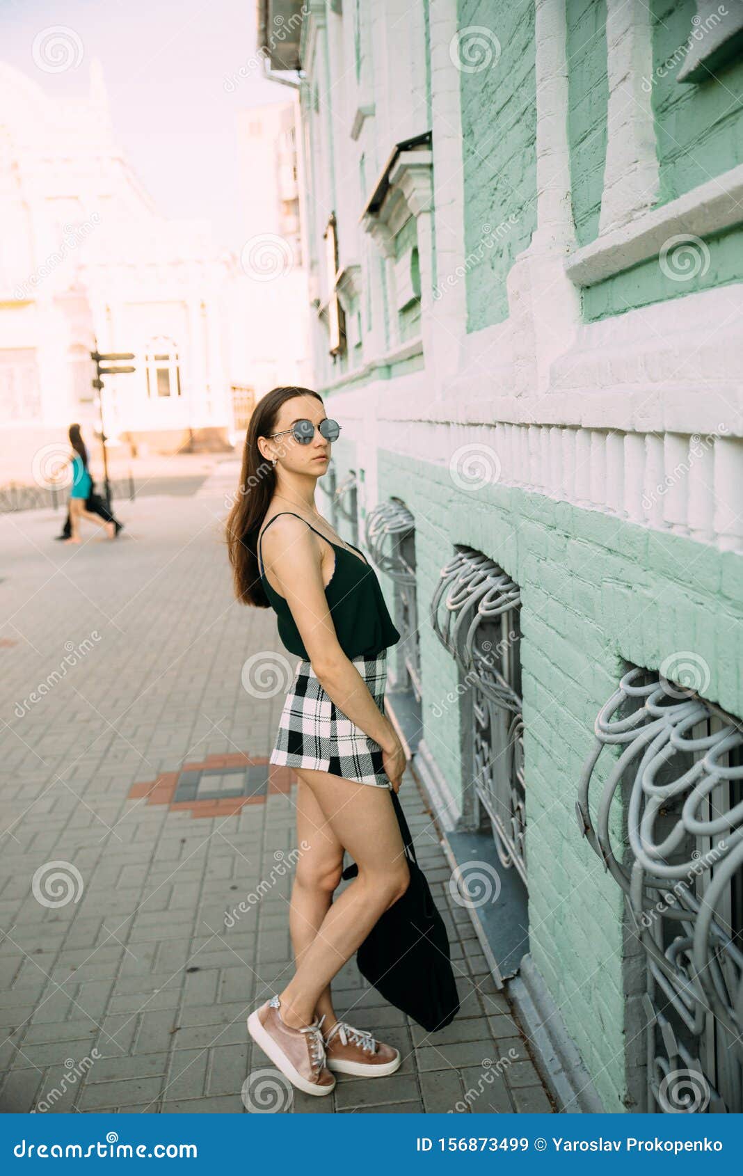 Girl In A T Shirt And Short Shorts Near The Building Stock Image