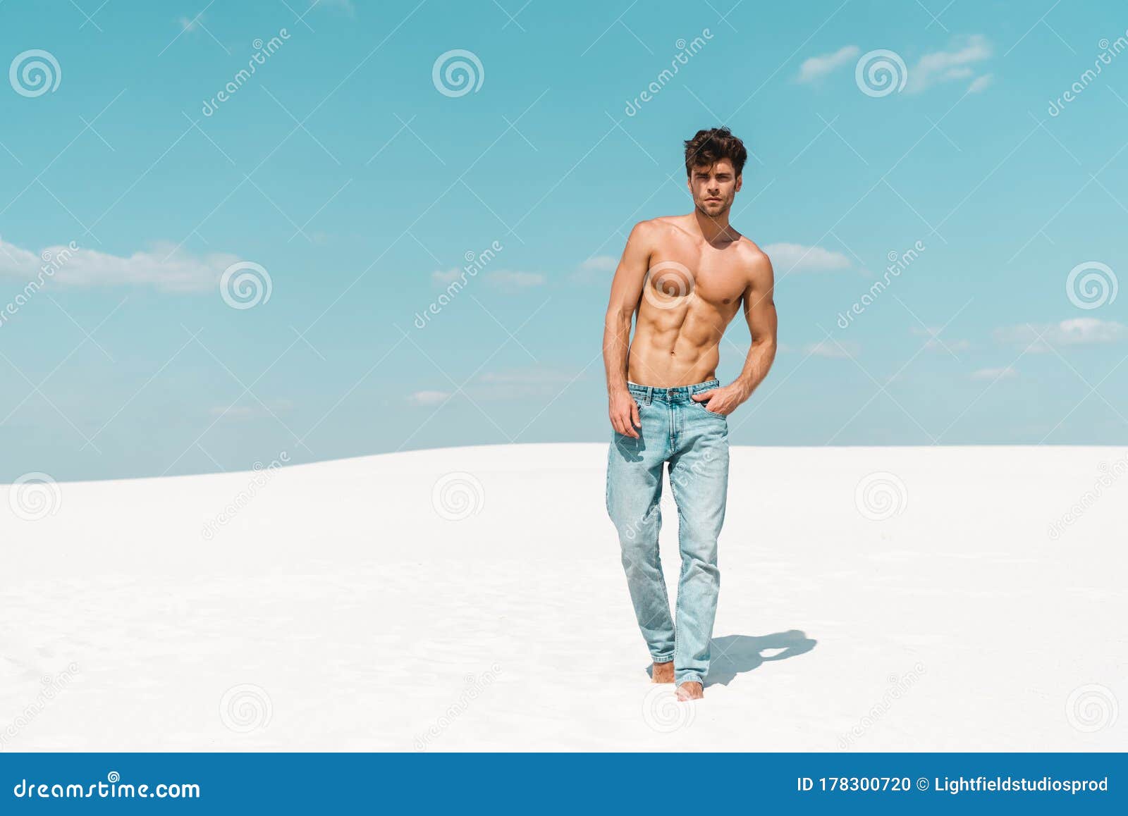 Man with Muscular Torso in Jeans on Sandy Beach Stock Photo - Image of ...