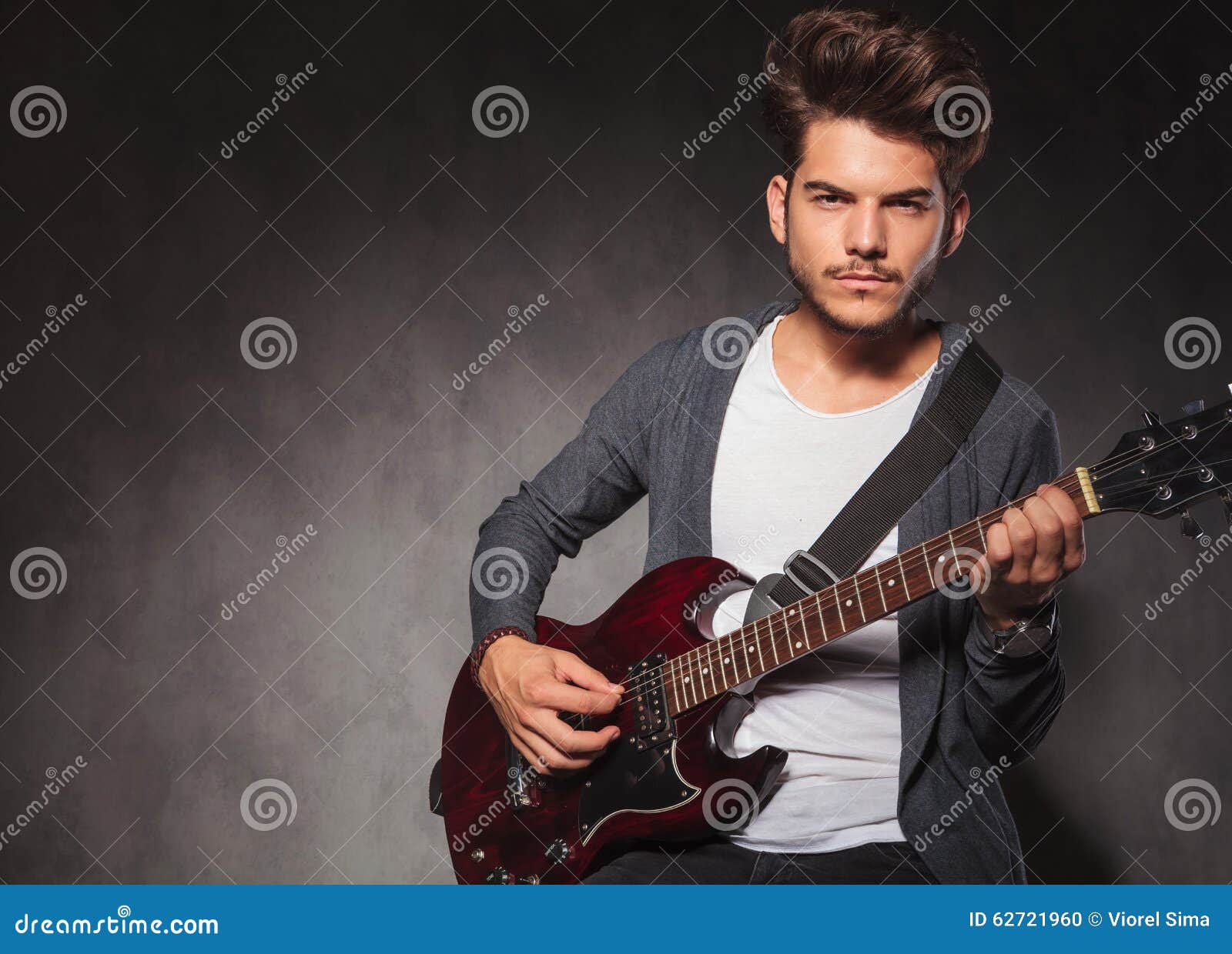 Man Playing Guitar Looking at the Camera Stock Photo - Image of music ...