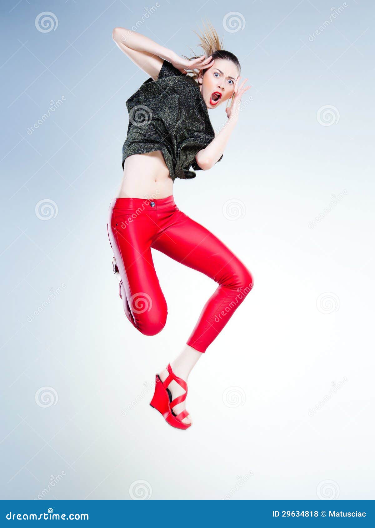 Model with Slim Body Dressed in Red Jumping in the Studio Stock Photo ...