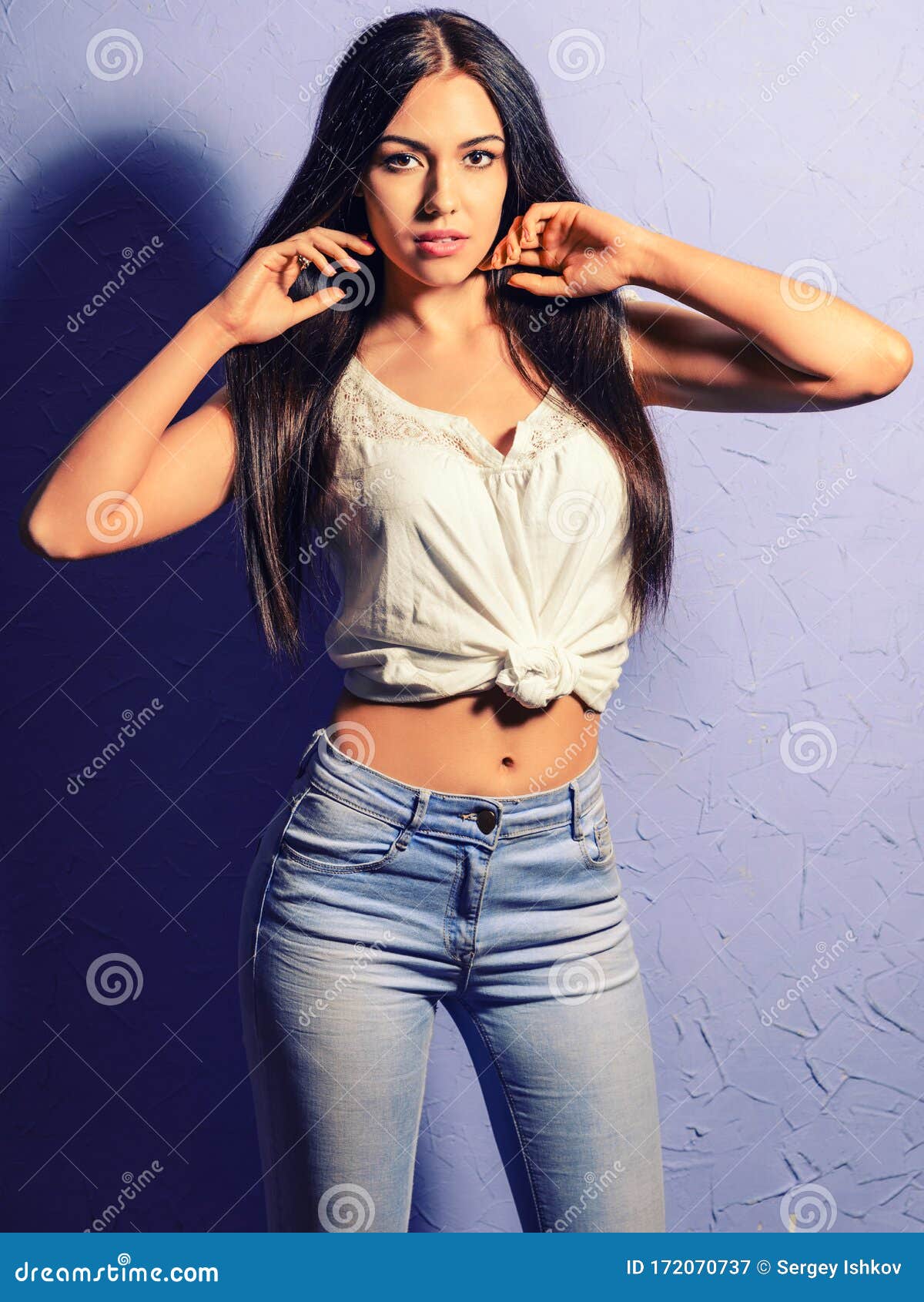 Tanned Brunette Girl In A White Vest And Jeans Stock Image Image Of