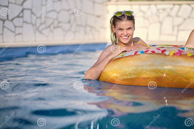 Woman In Bikini On The Sun Tanned Slim And Shapely Body Is Posing Near