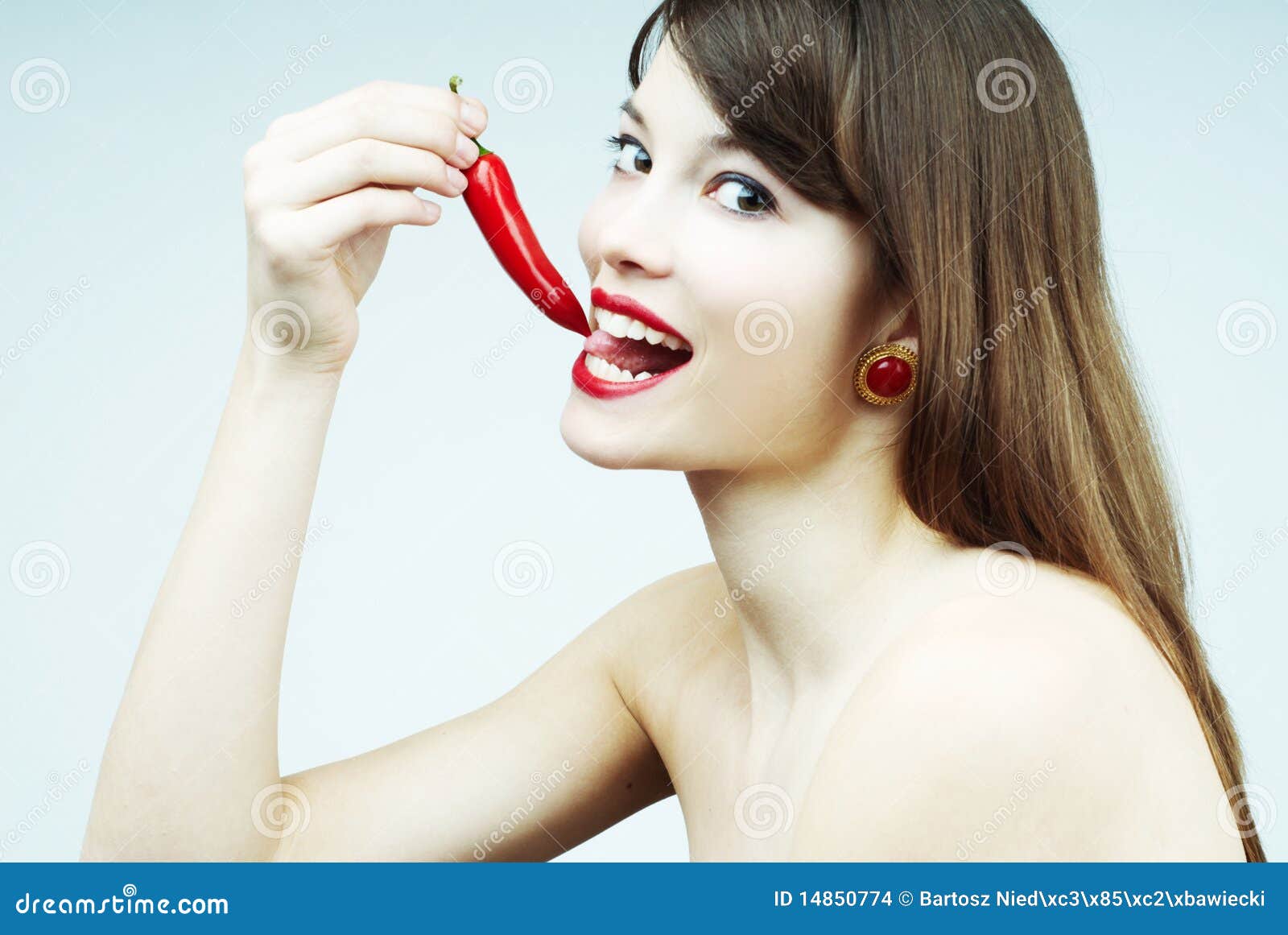 Woman Biting a Chili Pepper Stock Photo - Image of pepper, cute: 14850774