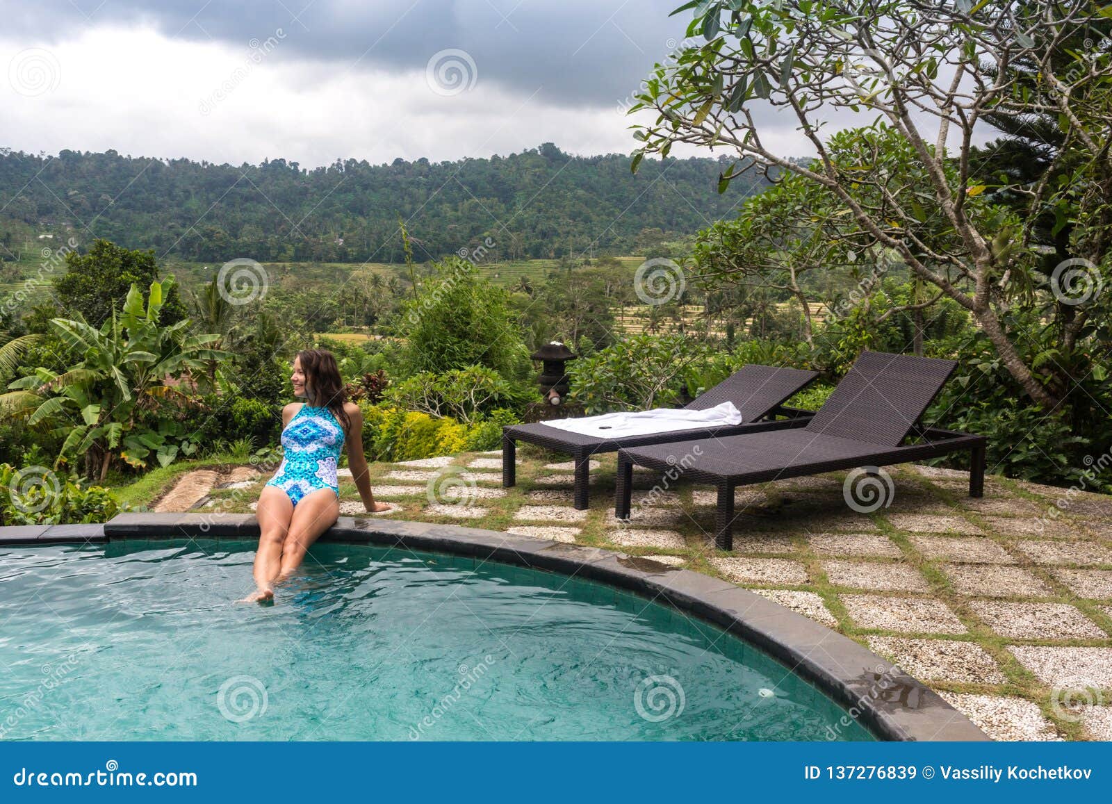 Woman Enjoying The Sun At Infinity Summer Swimming Pool At Luxurious