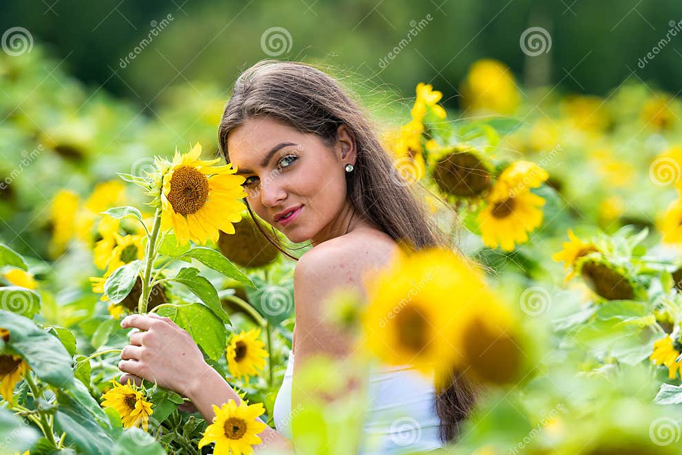 Young Brunette With Long Hair In Sunflower Field On Summer Day Woman